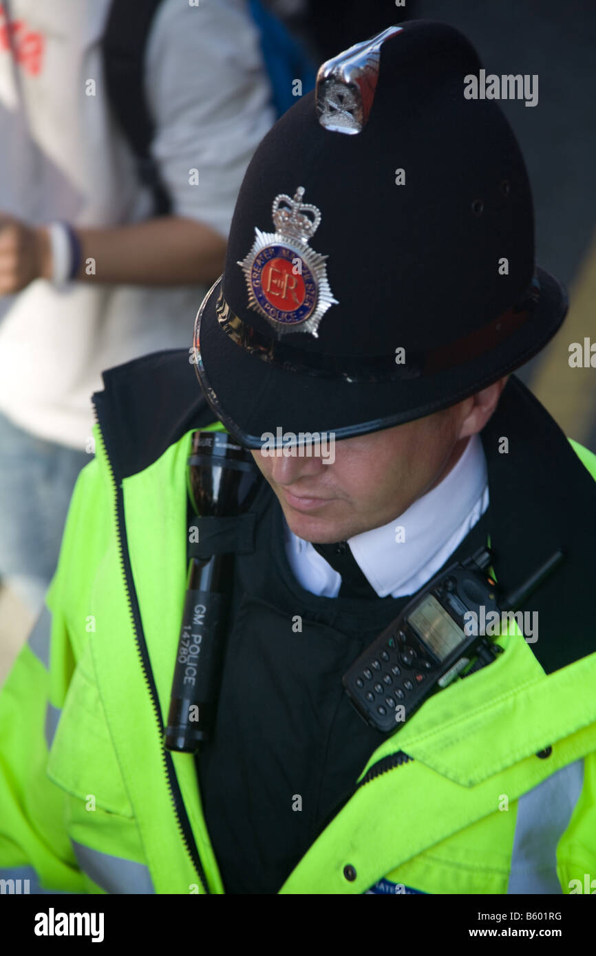 British Policeman in Traditional Helmet and High Visibility Jacket ...