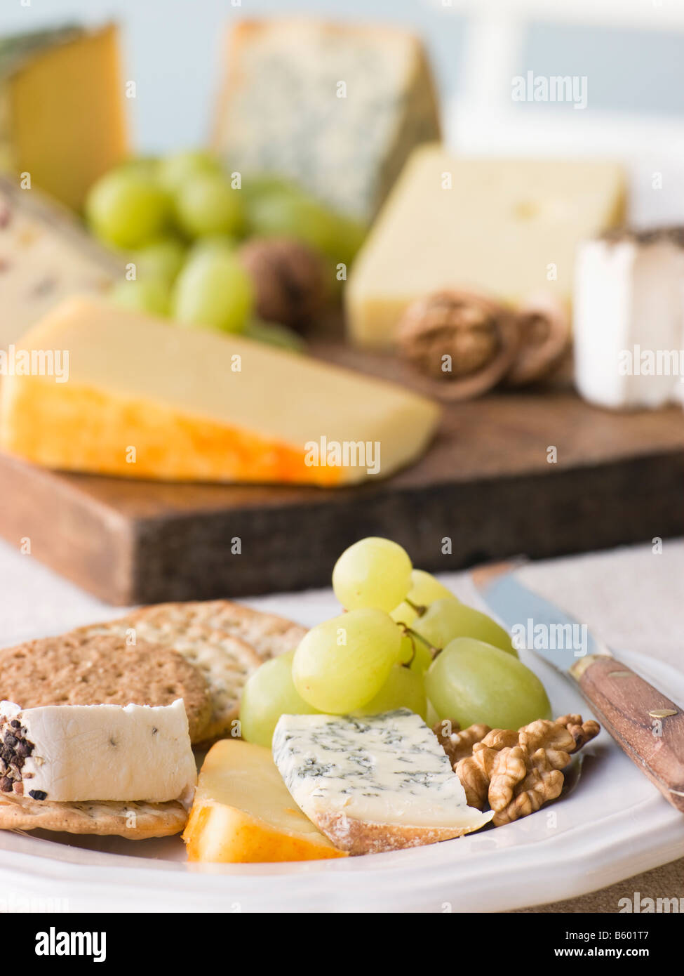 Plate of Cheese and Biscuits with a Cheese Board Stock Photo - Alamy
