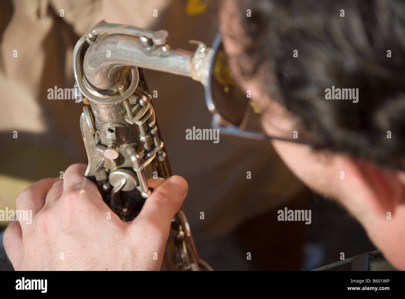 Close up rear view of a man playing a saxophone Stock Photo - Alamy