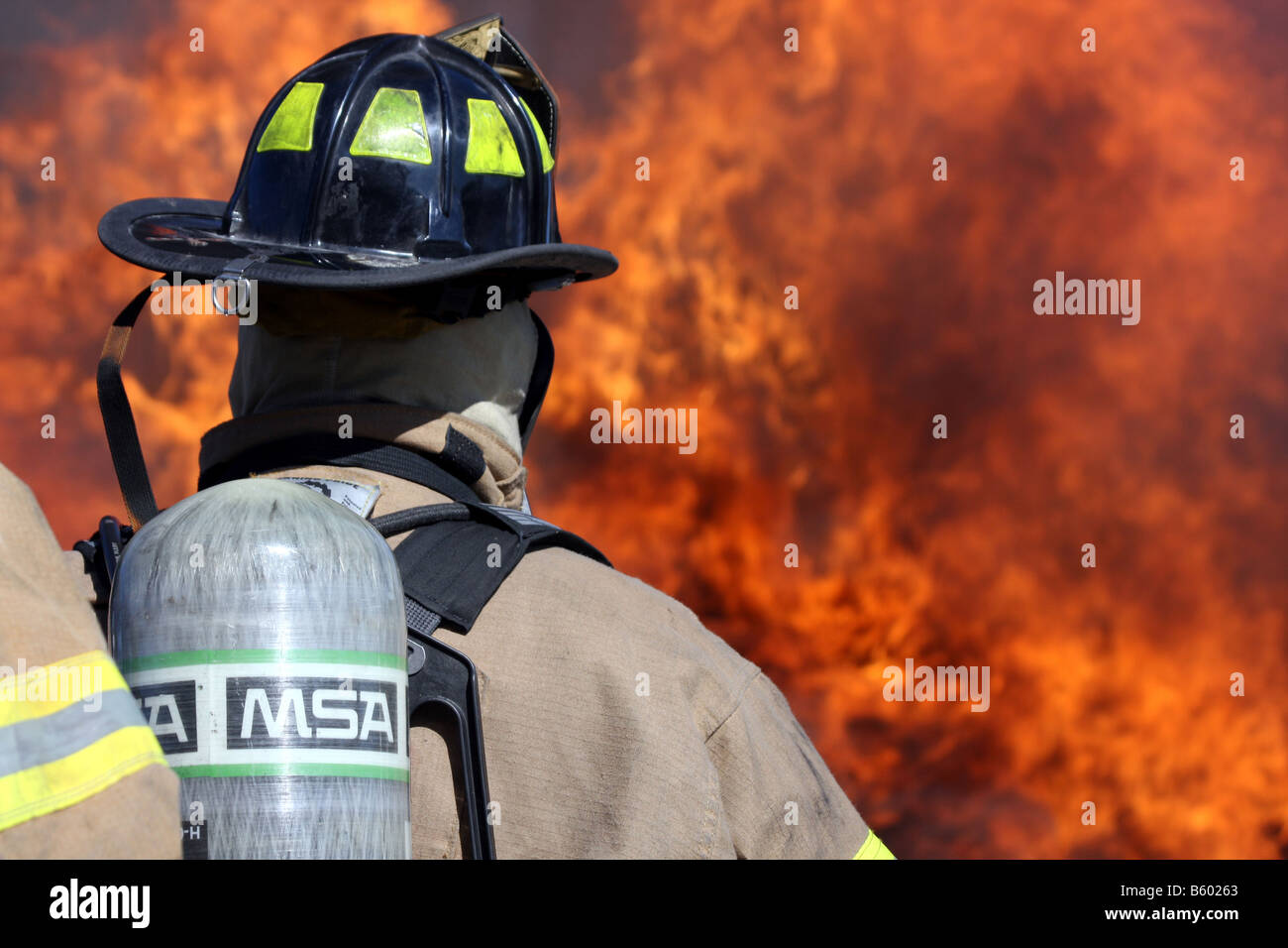 Firefighters in front of a blazing fire inferno Stock Photo - Alamy