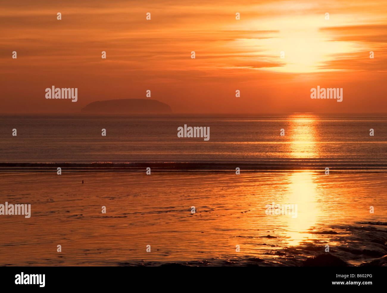 Vivid orange sunset taken from the mudflats at Sandpoint near Weston ...