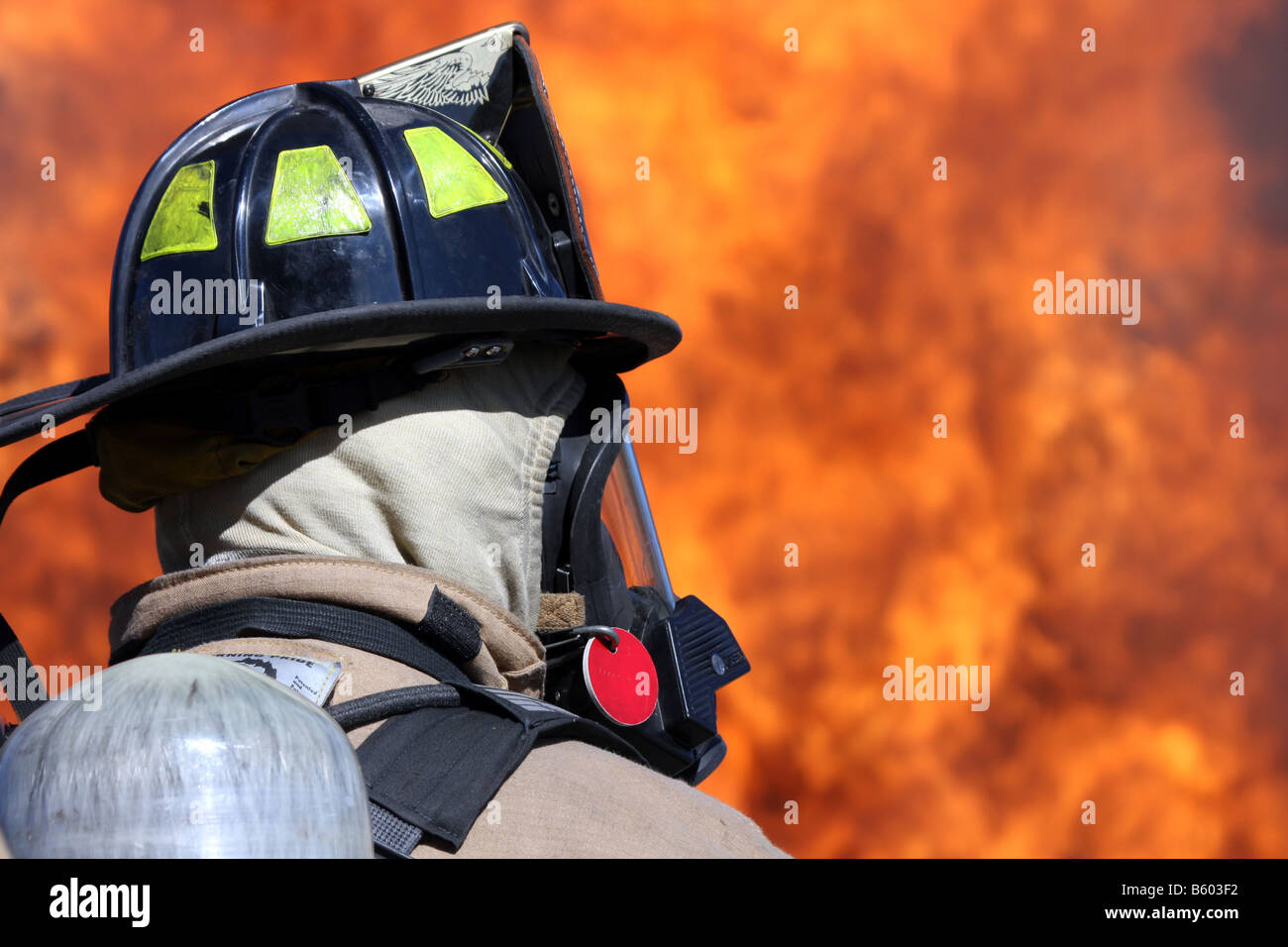 Profile of a Firefighter in front of a blazing fire Stock Photo - Alamy