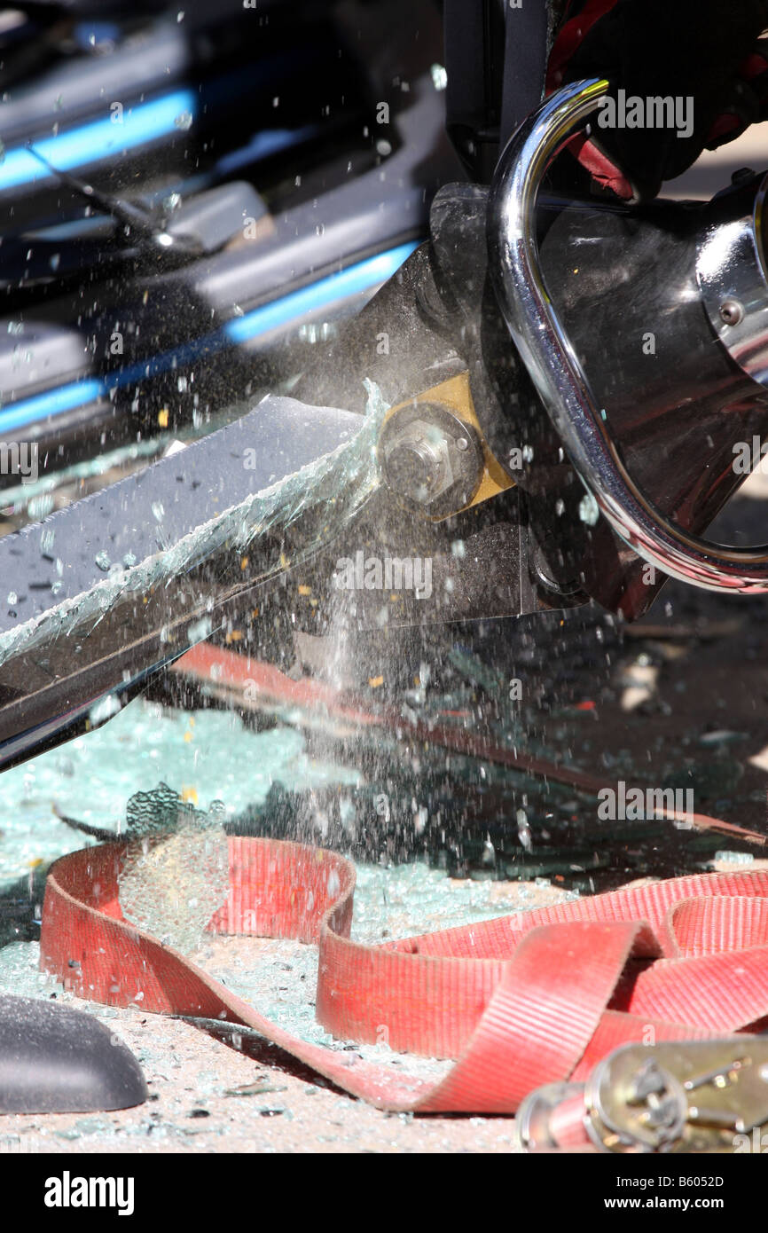 The jaws of life extrication tool is cutting through a door jam and ...