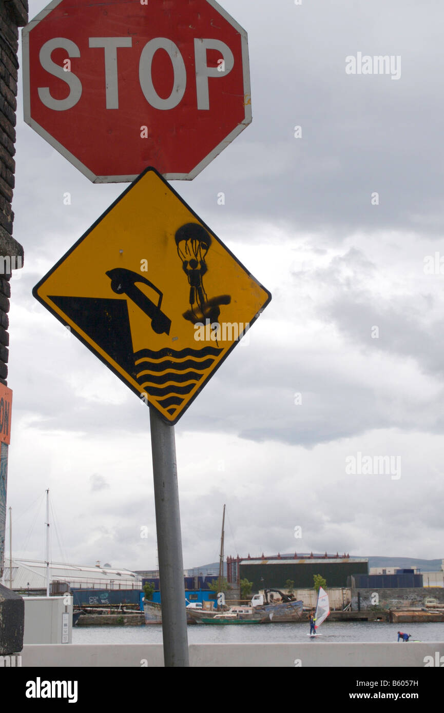 Grafitti on warning sign with parachute added in beside docklands in ...