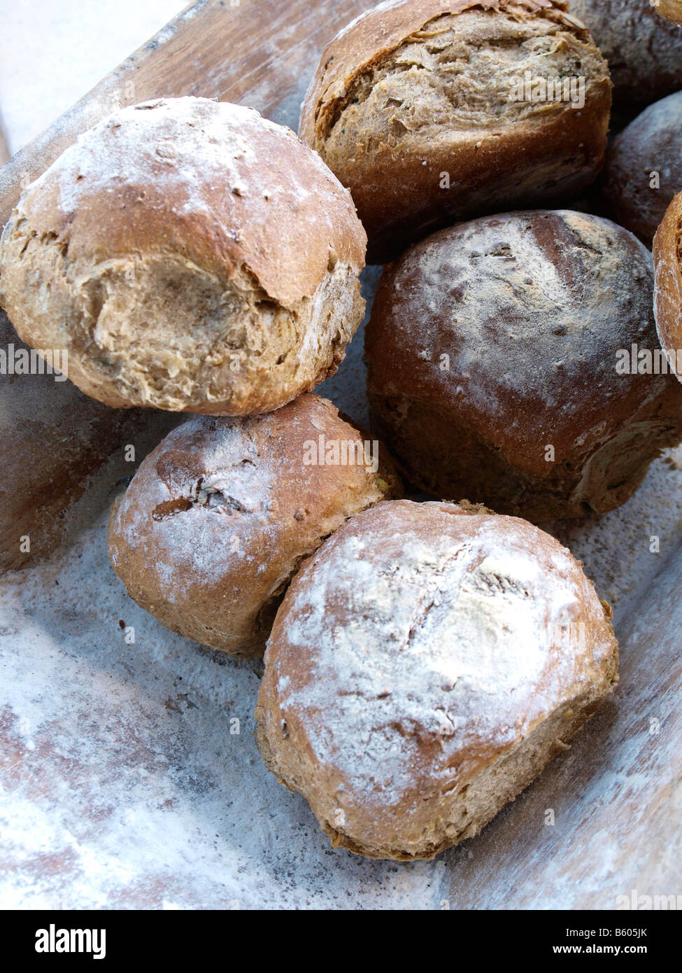 Freshly baked loafs of bread in a wooden tray with flour Stock Photo ...