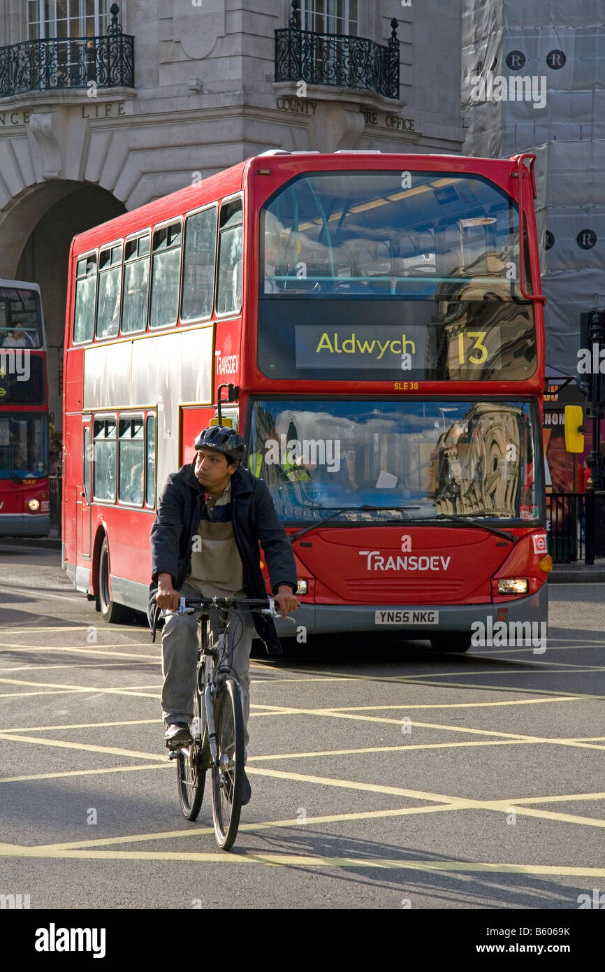 Bicyclist and a double decker bus in the city of London England Stock Photo - Alamy