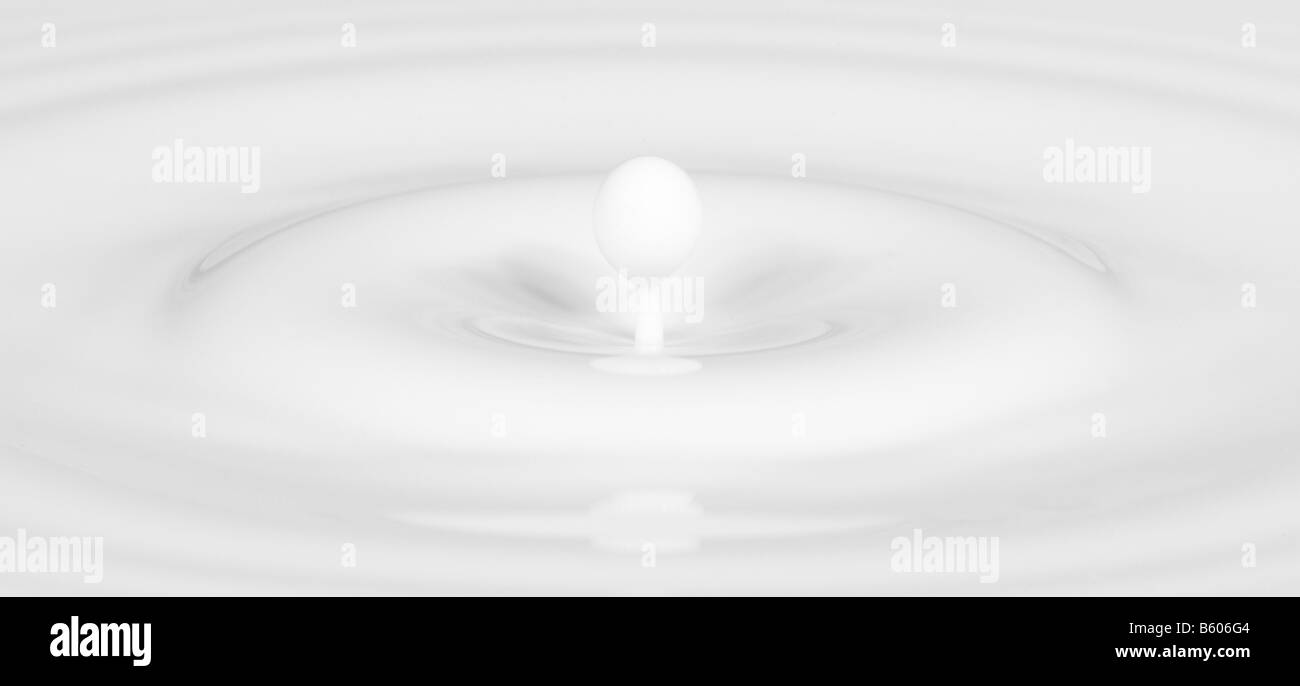 Milk drop splashing down Stock Photo - Alamy