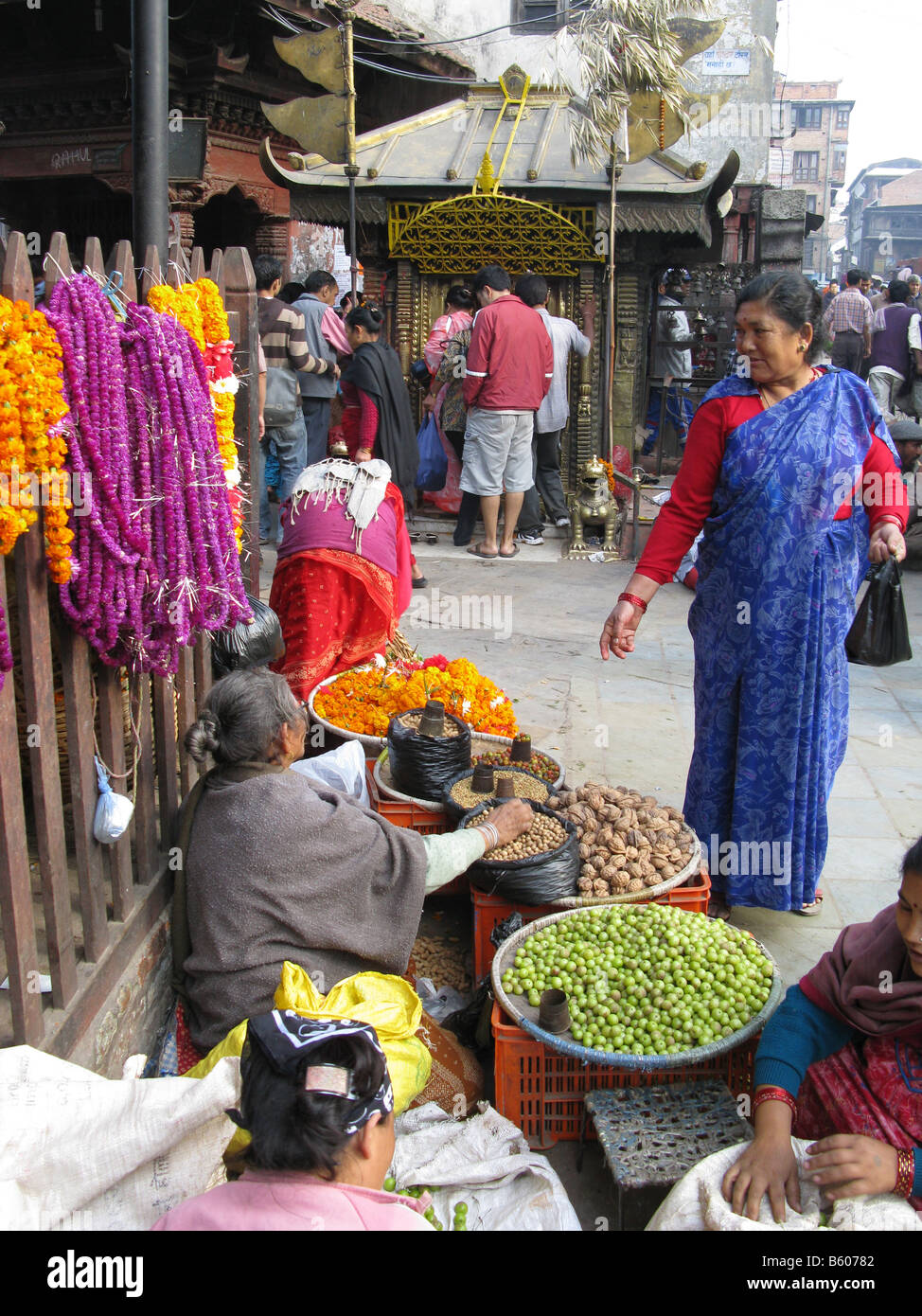 Nut and fruit seller at the early morning market outside the ...