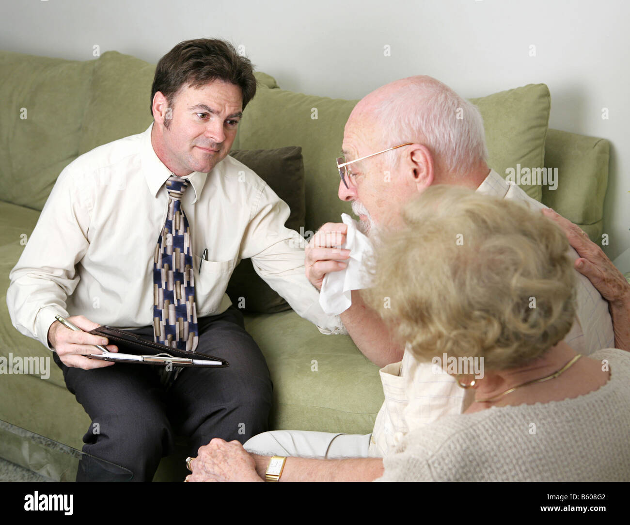 A counselor helping a grieving couple The husband is crying Stock Photo ...