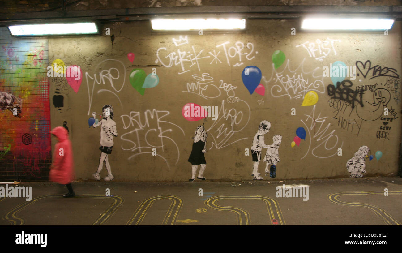 childs play playing child Banksy graffiti artist art Stock Photo - Alamy