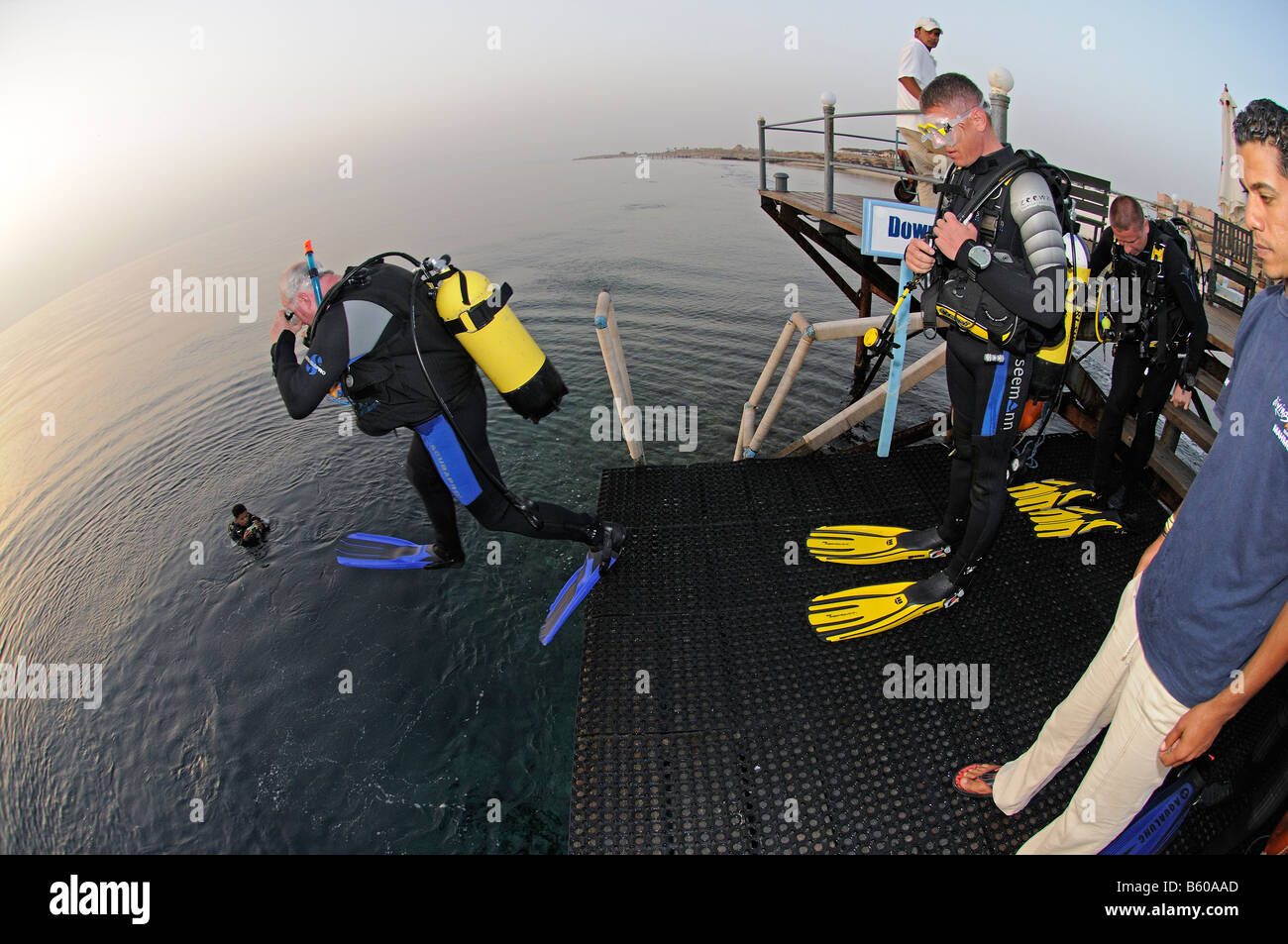 scuba diver jumping from jetty Stock Photo - Alamy