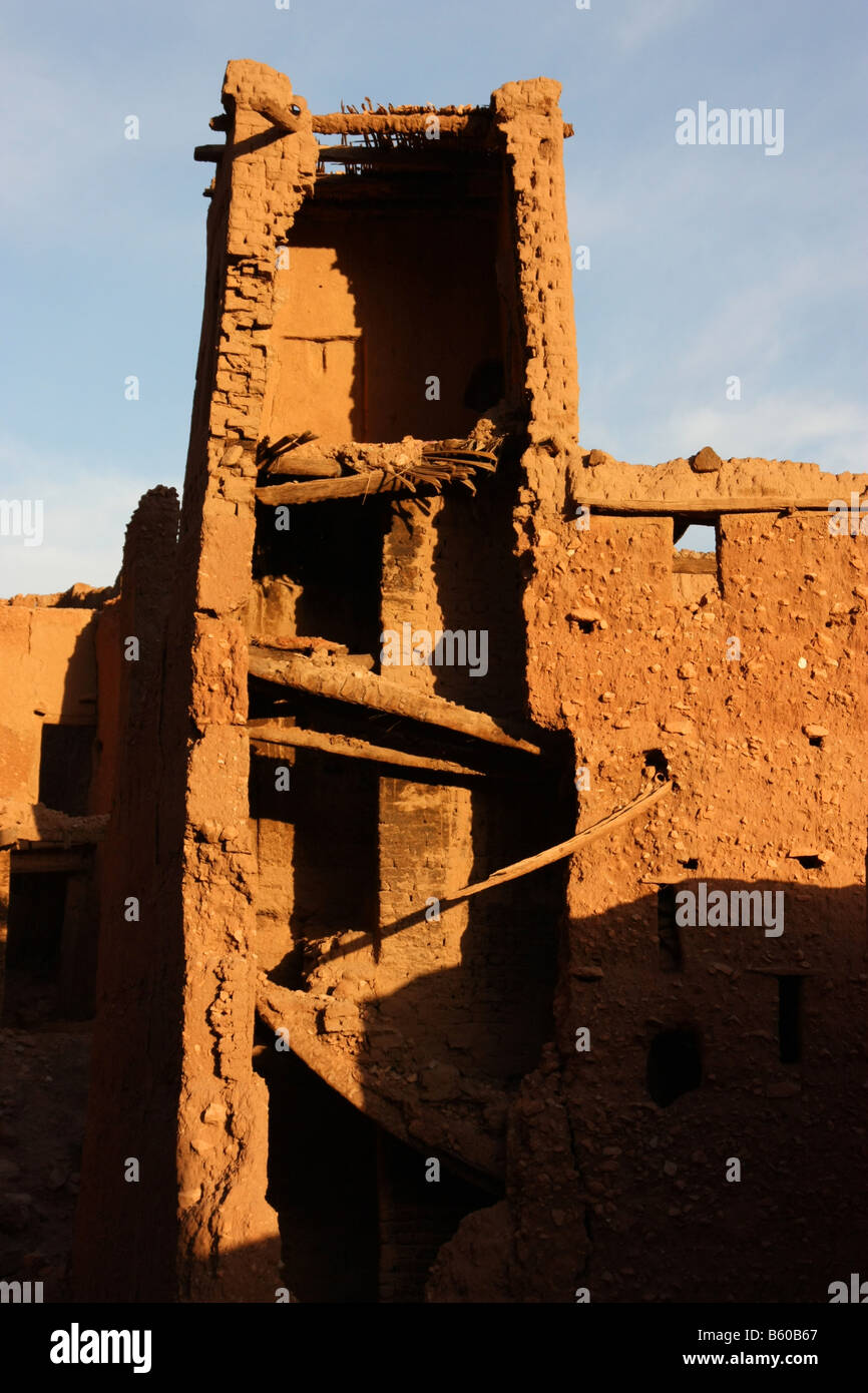 Deserted Kasbah town. A partially collapsed mud built tower in near ...