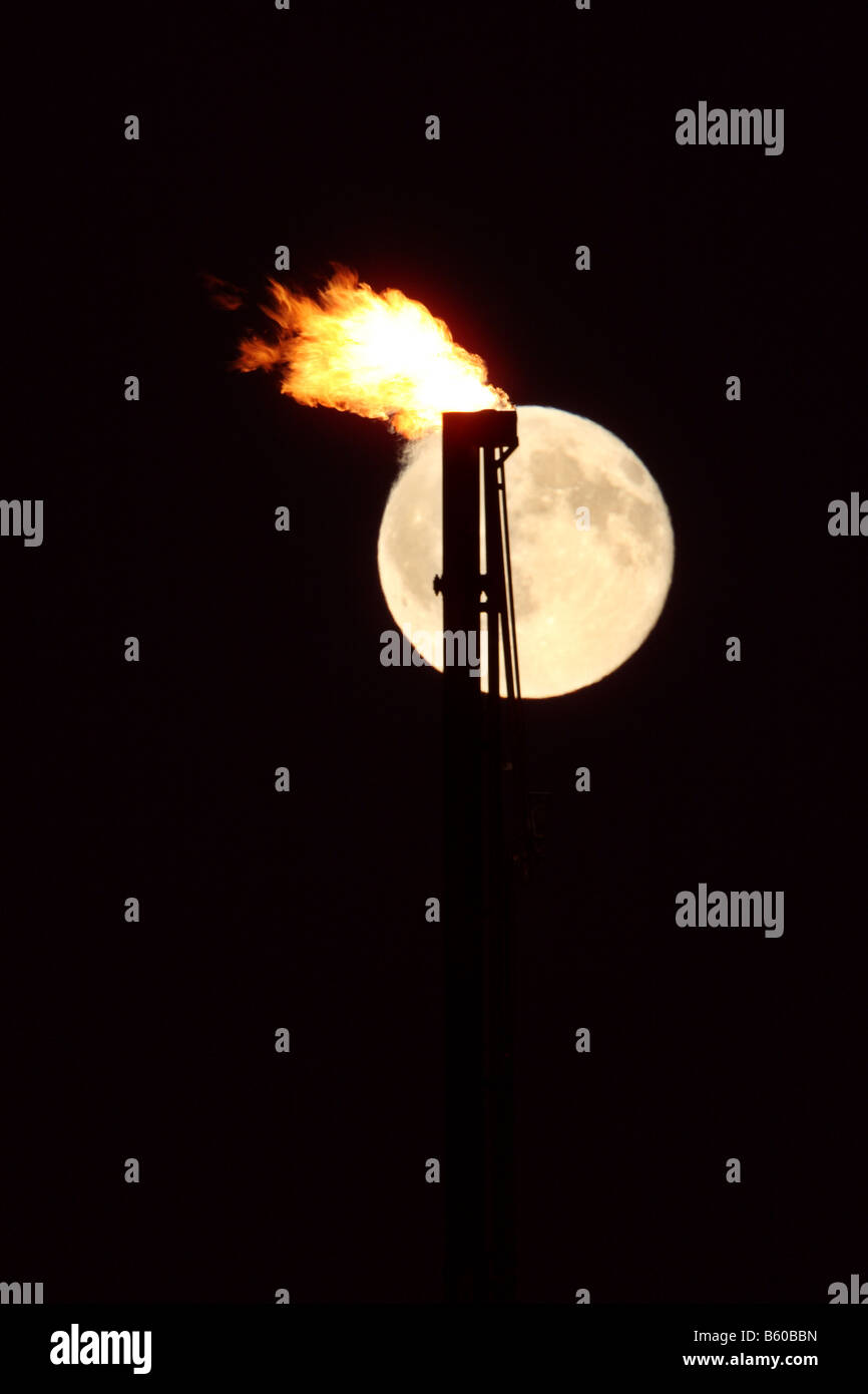 Full moon behind natural gas flame Stock Photo - Alamy
