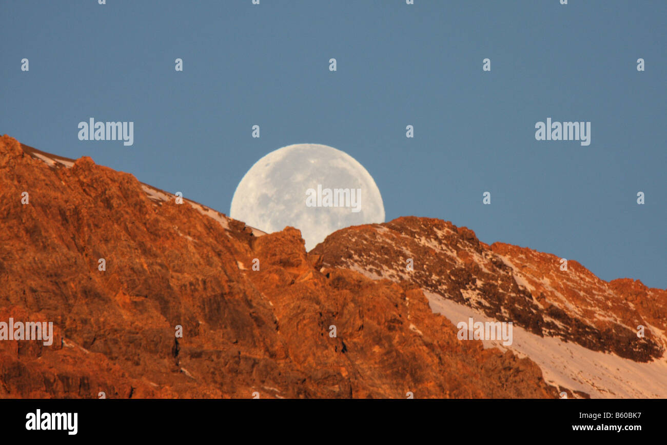Full moon behind mountain in scenic Alberta Stock Photo - Alamy