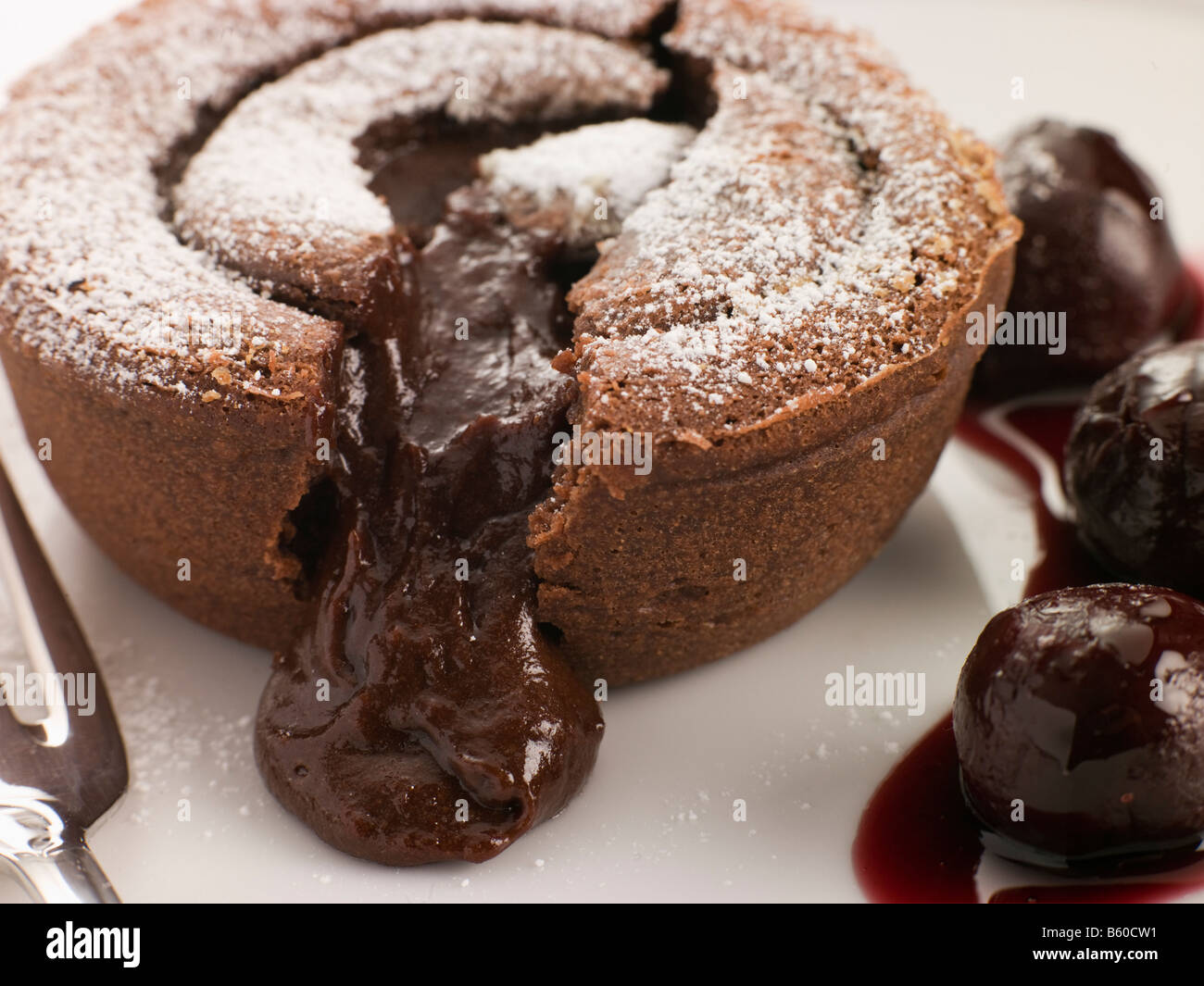 Hot Chocolate Fondant Pudding with Black Cherry Syrup Stock Photo - Alamy