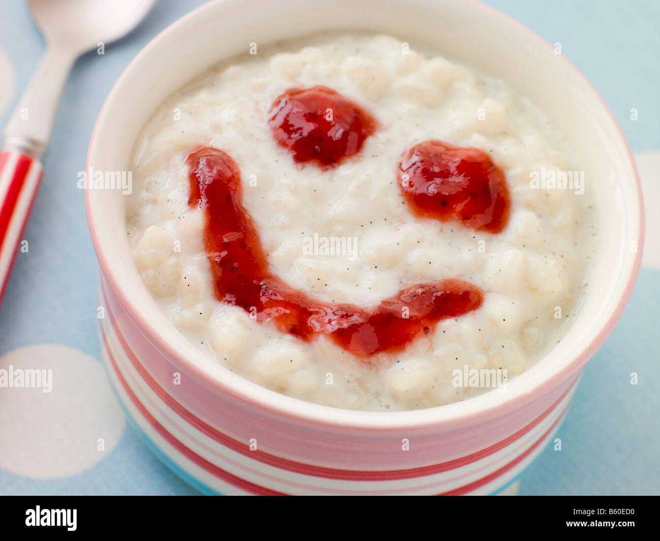 Bowl of Creamed Rice Pudding with a Strawberry Jam Face Stock Photo - Alamy