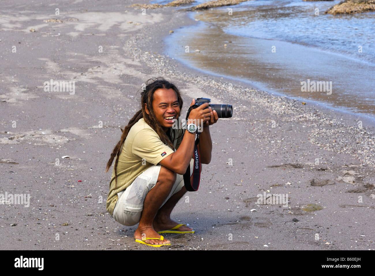 Divemaster Santoso of MS-Felicia taking pictures on the beach, Komodo ...