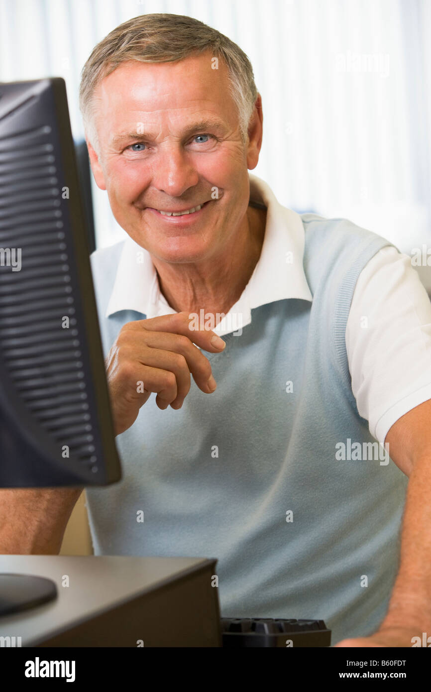 Man sitting at a computer terminal (high key Stock Photo - Alamy