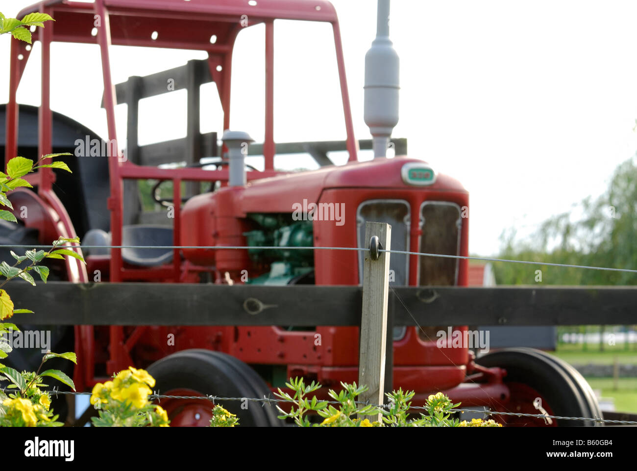 Red tractor kids attraction Sweden Stock Photo - Alamy