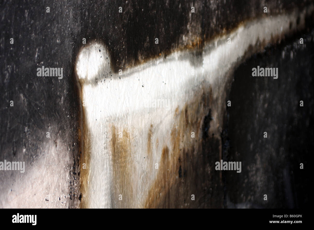 A burn pattern on the wall of a structure after a fire had burnt the ...