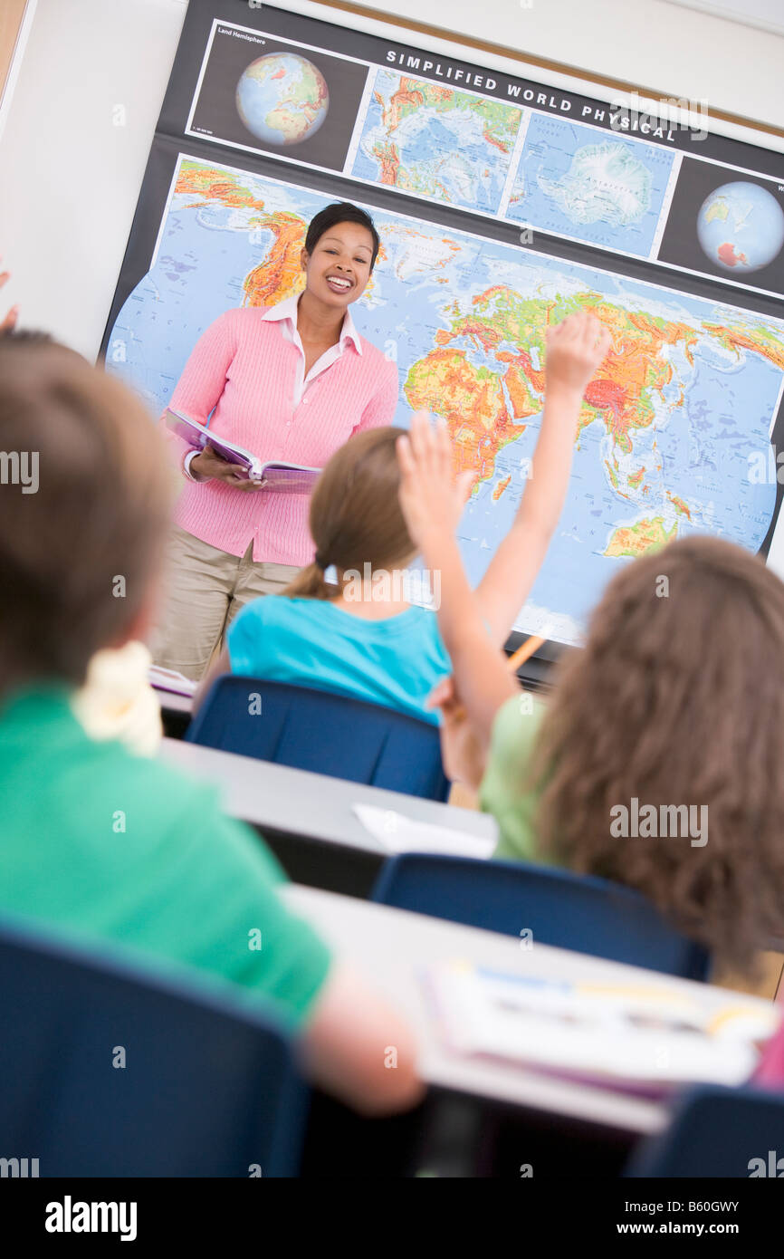 Students in geography class volunteering for teacher (selective focus ...