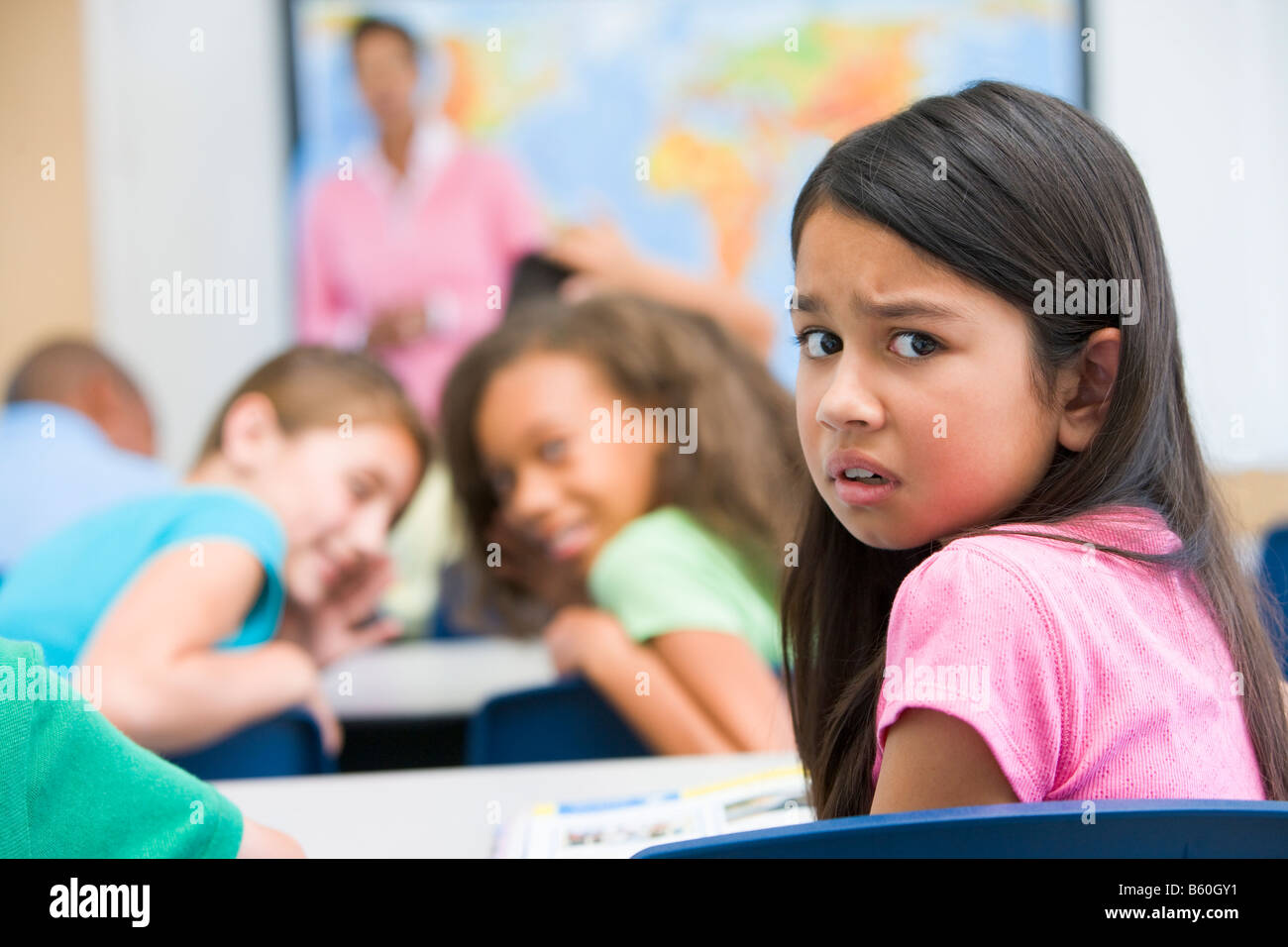 Student in class being bullied by students in background (selective ...