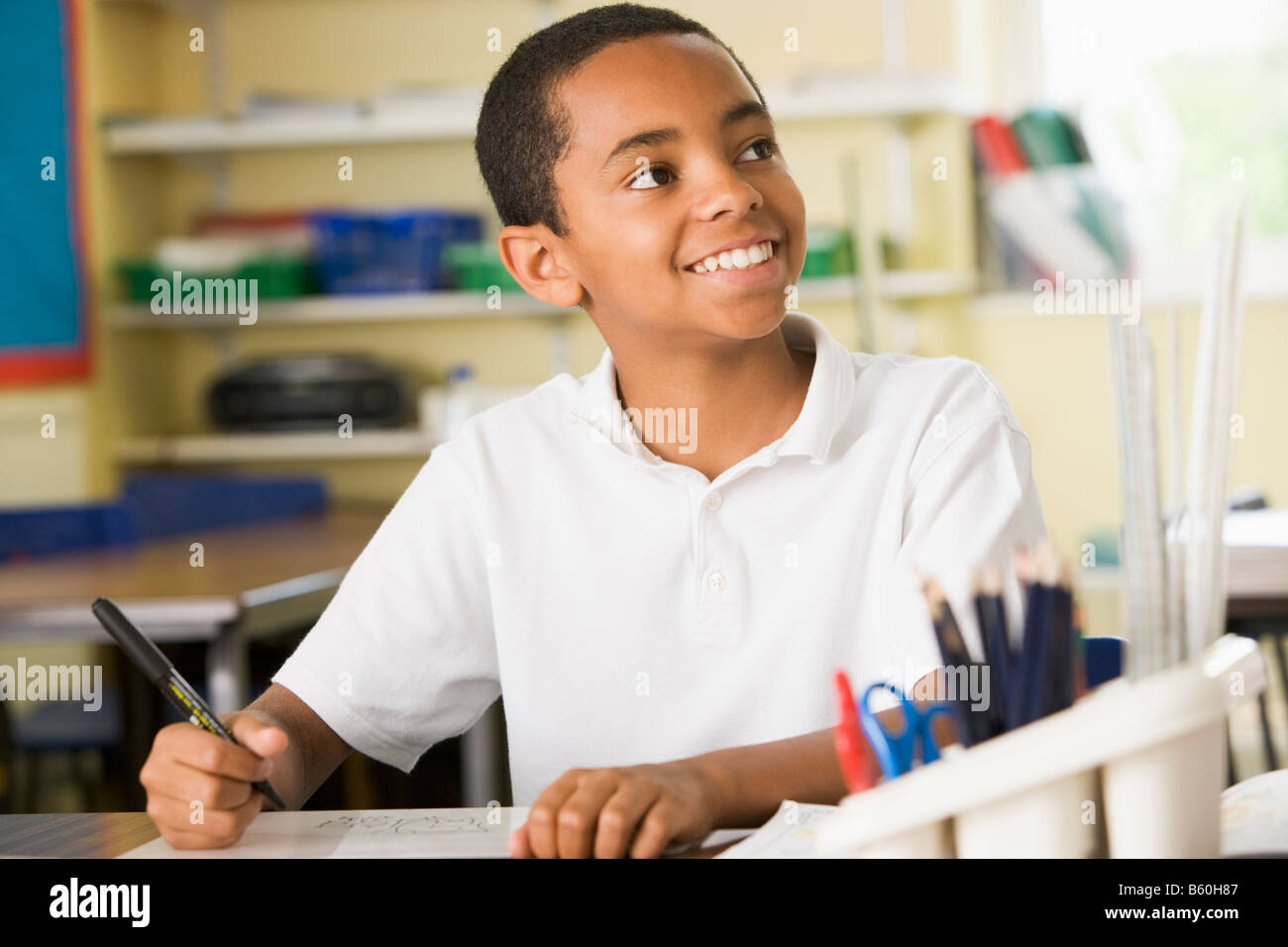 Student in class taking notes Stock Photo - Alamy