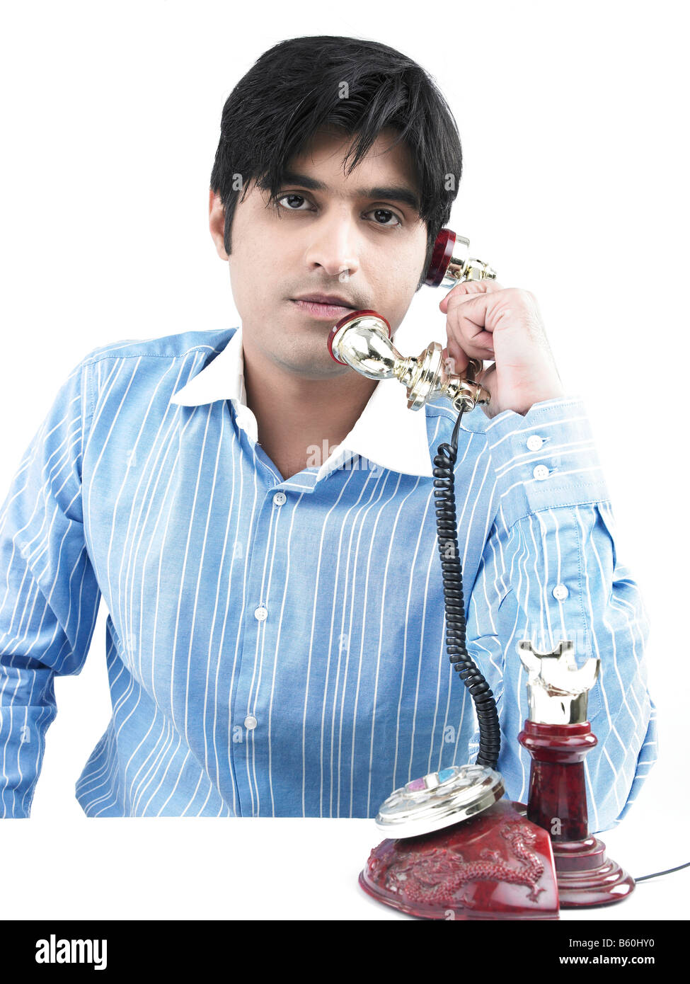 asian guy talking on an ornate phone Stock Photo - Alamy