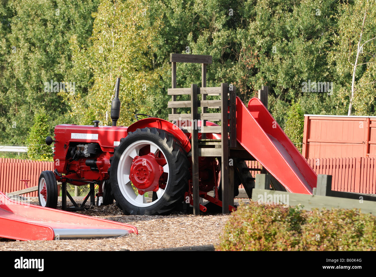 Red tractor kids attraction Sweden Stock Photo - Alamy