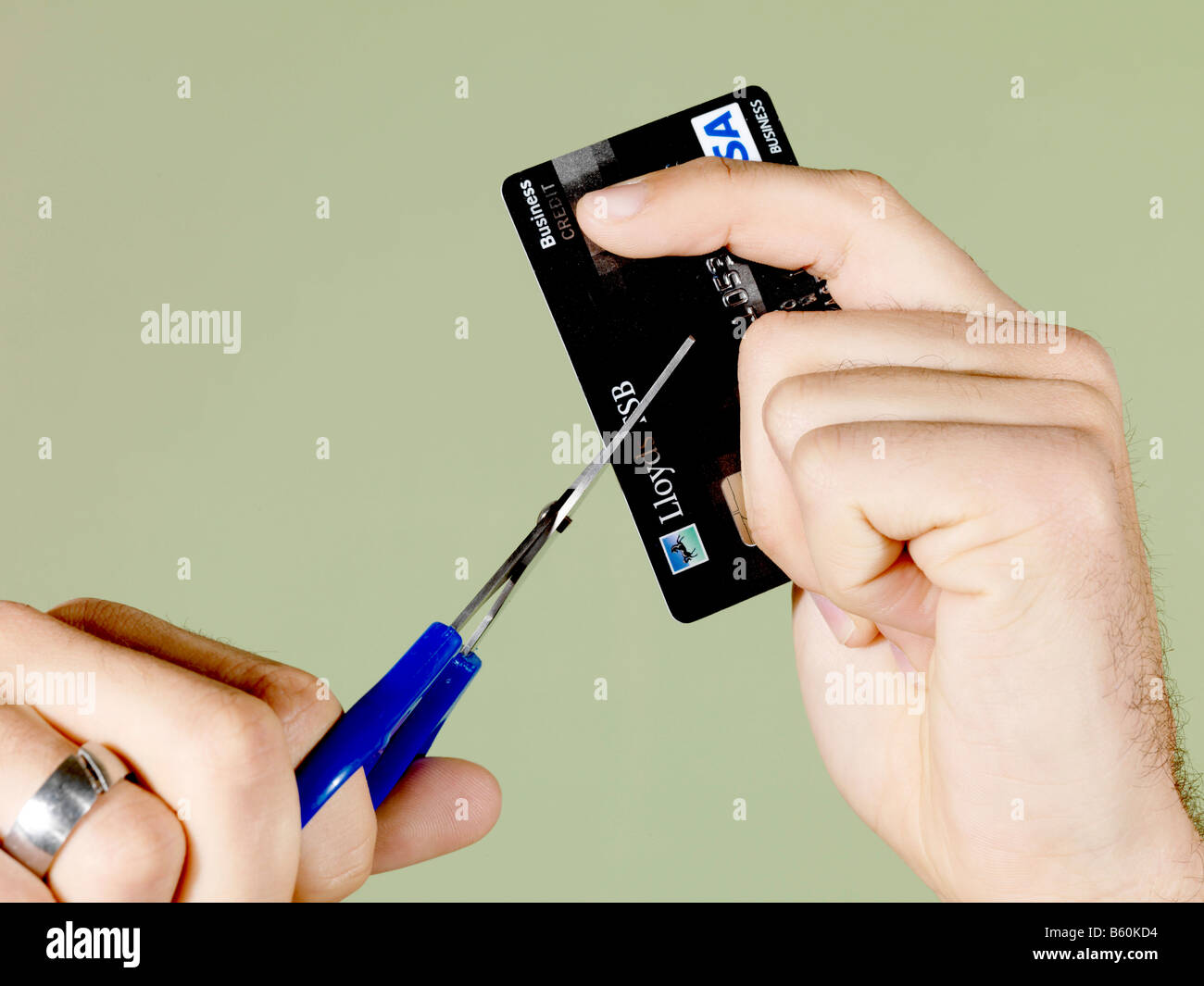 Young Man Cutting Up Credit Card Model Released Stock Photo - Alamy