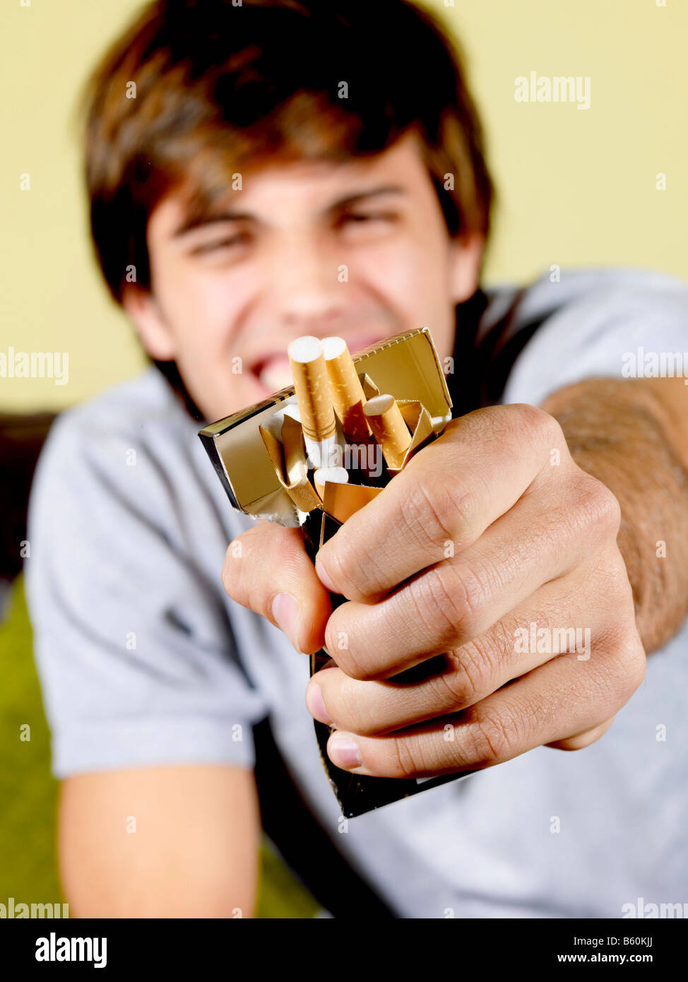 Young Man Squashing Cigarettes Model Released Stock Photo - Alamy