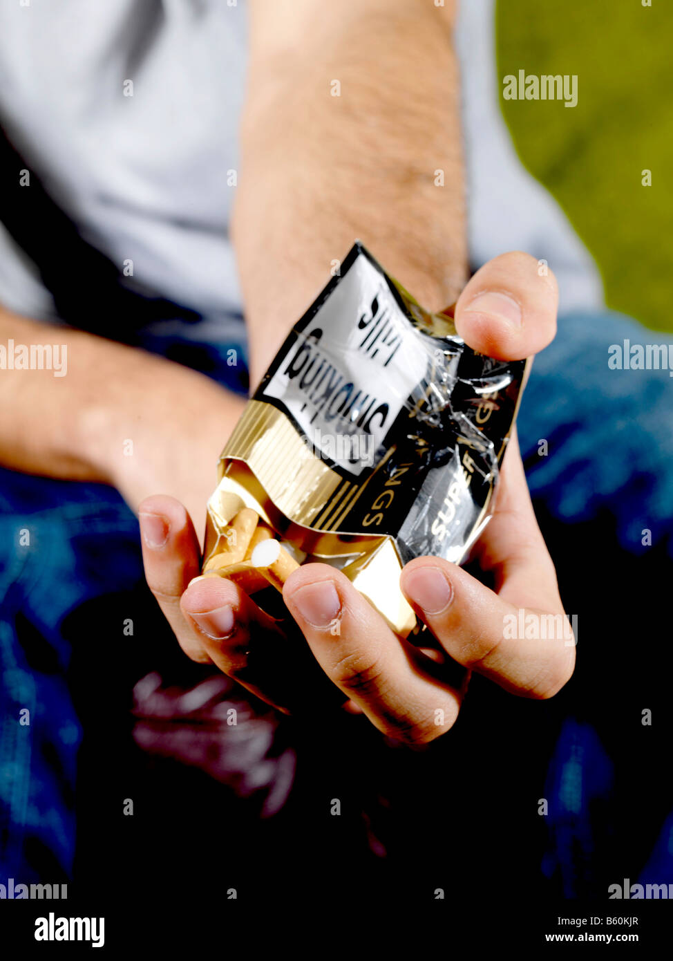 Young Man Squashing Cigarettes Model Released Stock Photo - Alamy