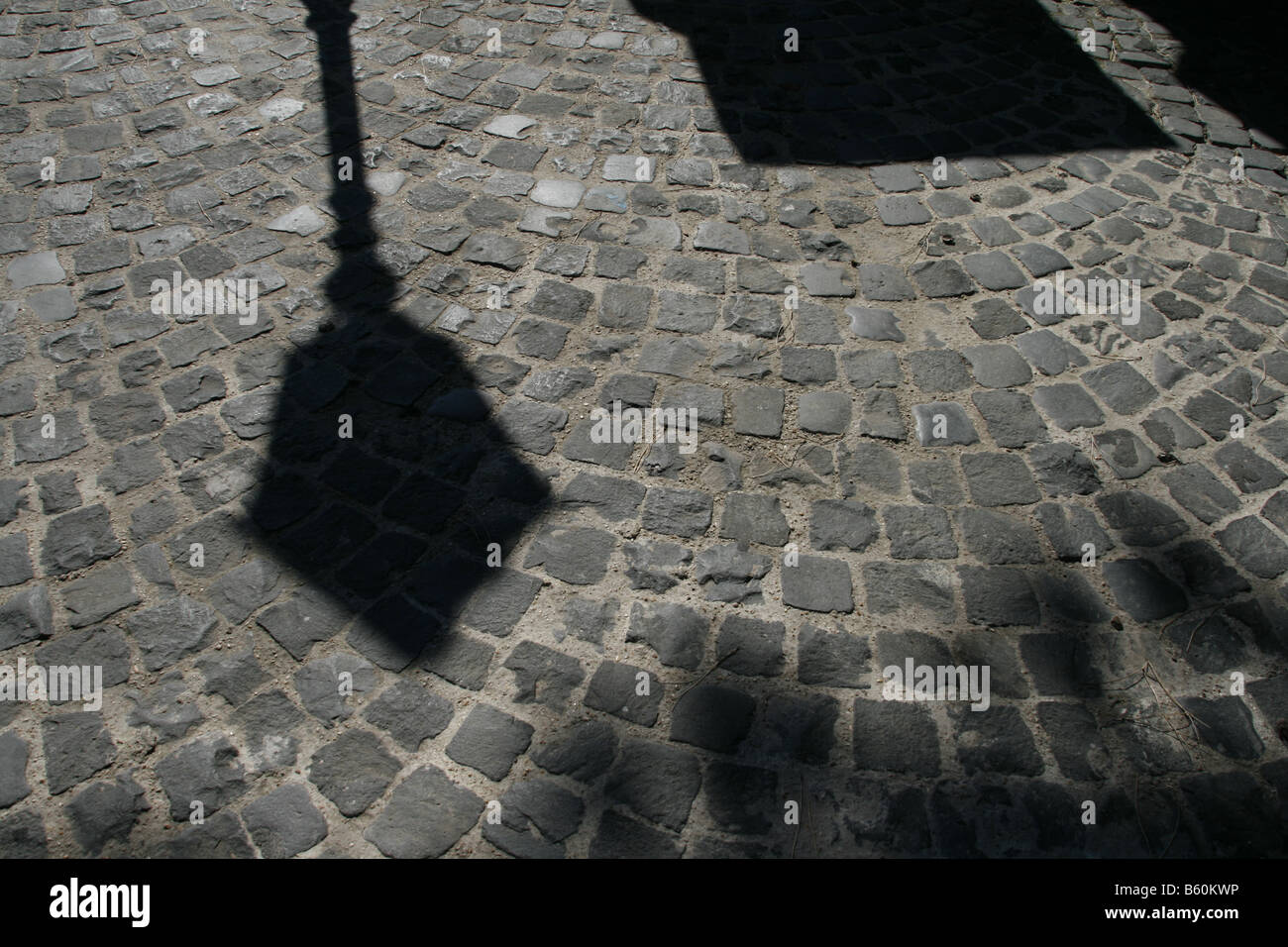 lamp post shadow on street road in rome, italy Stock Photo - Alamy