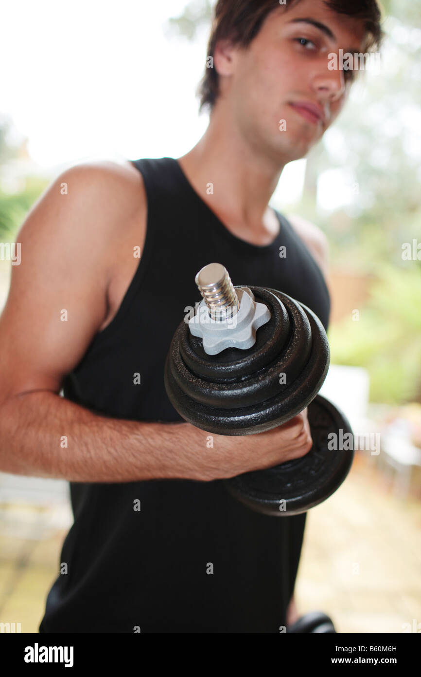 Teenage boy lifting weights hi-res stock photography and images - Alamy