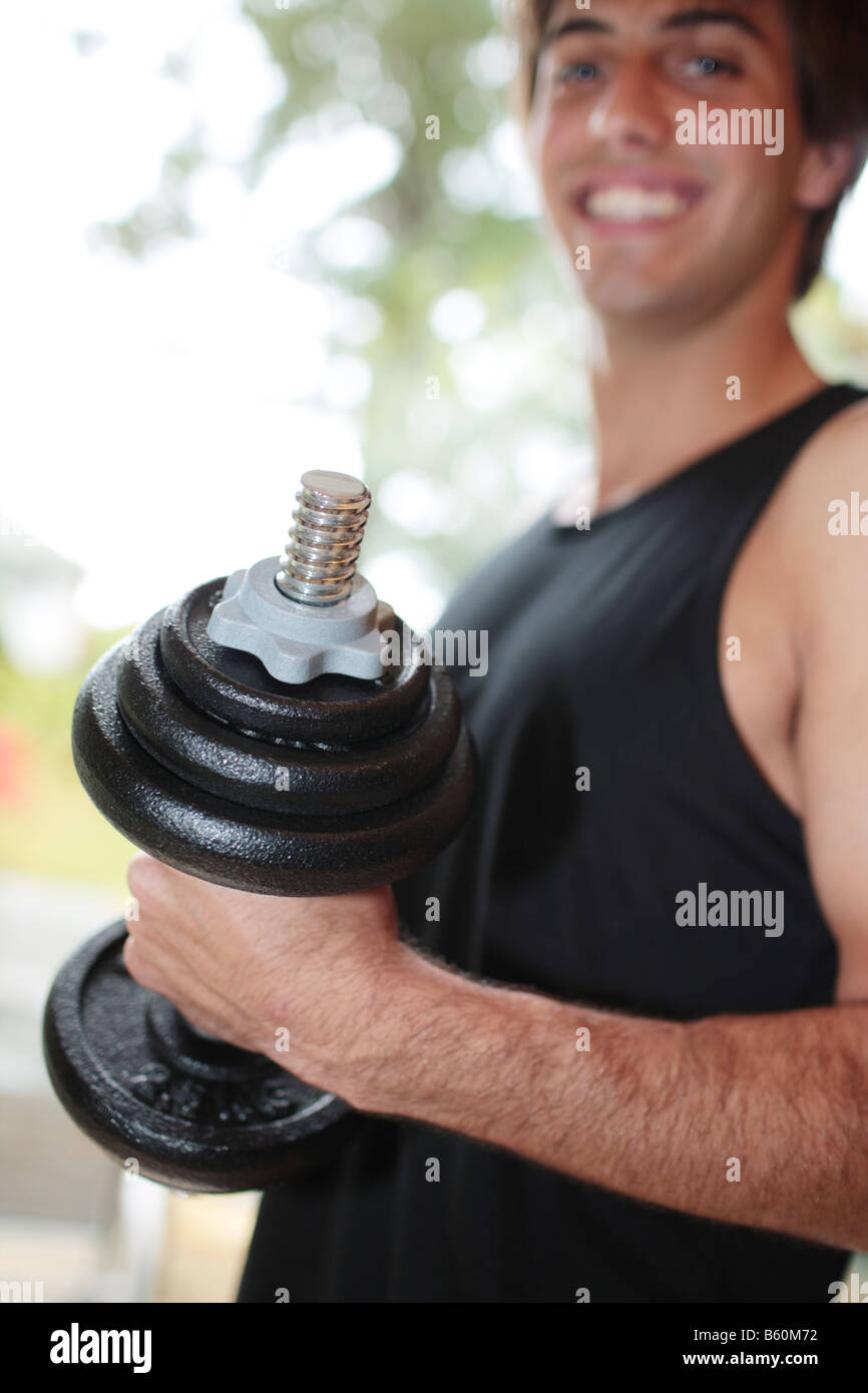 Teenage boy lifting weights hi-res stock photography and images - Alamy