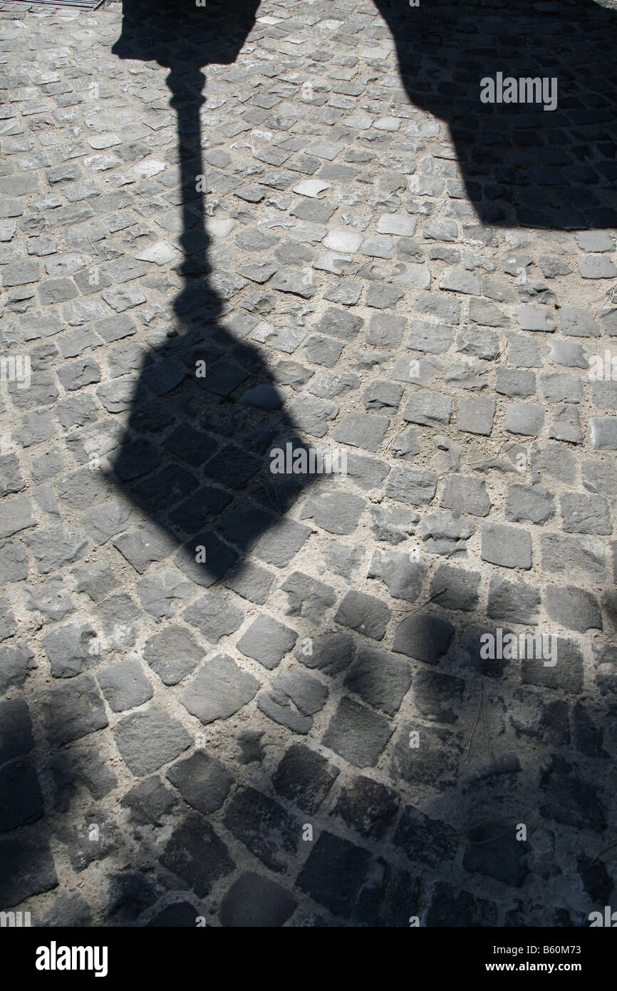 Lamp post shadow on street road in rome hi-res stock photography and ...