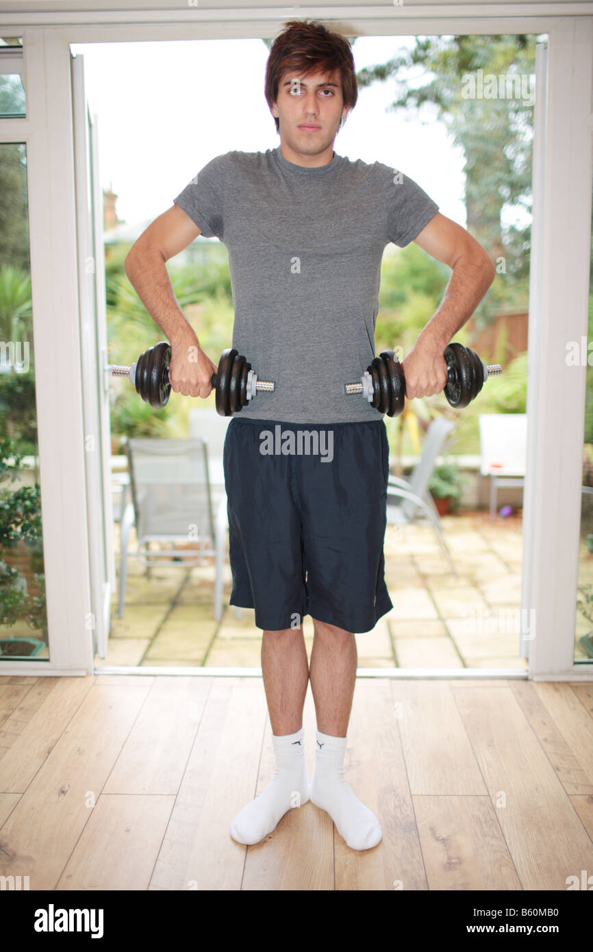 Teenage boy lifting weights hi-res stock photography and images - Alamy