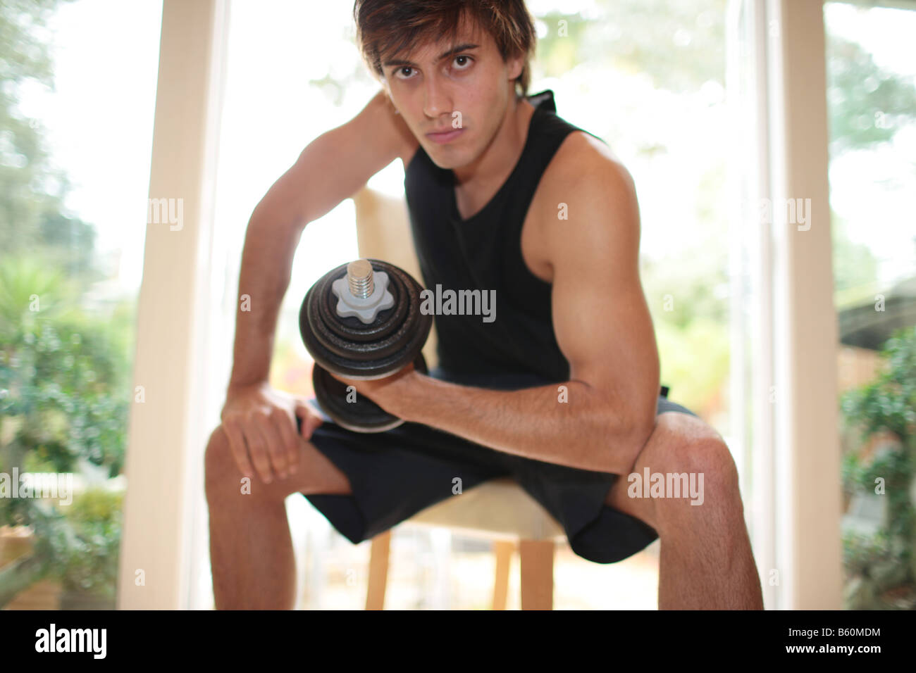 Young Man Lifting Weights Model Released Stock Photo - Alamy