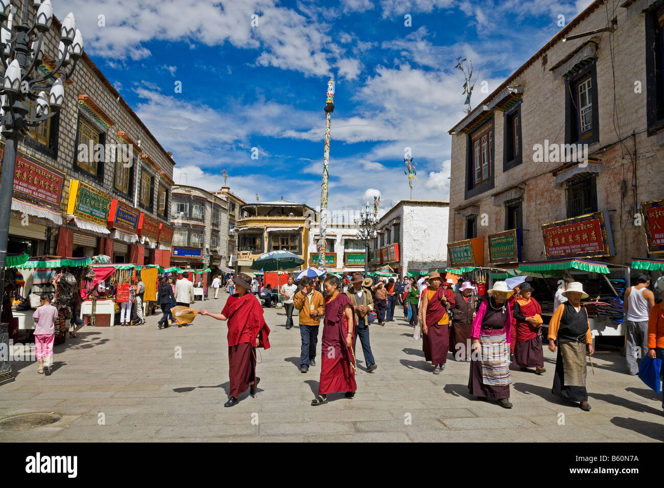Tibetan pilgrims walking clockwise around the Barkhor Lhasa Tibet ...