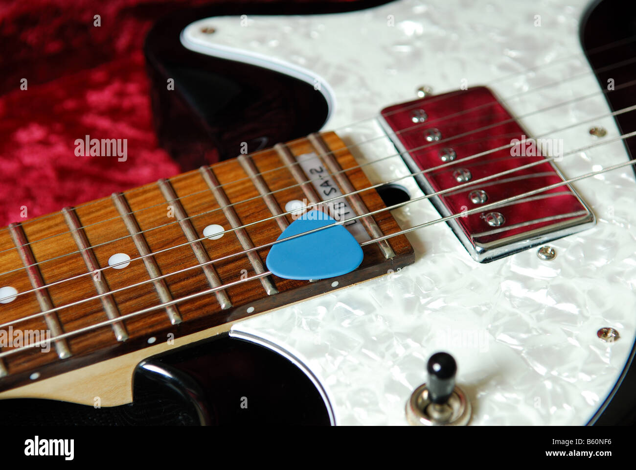 Guitar and plectrum Stock Photo - Alamy