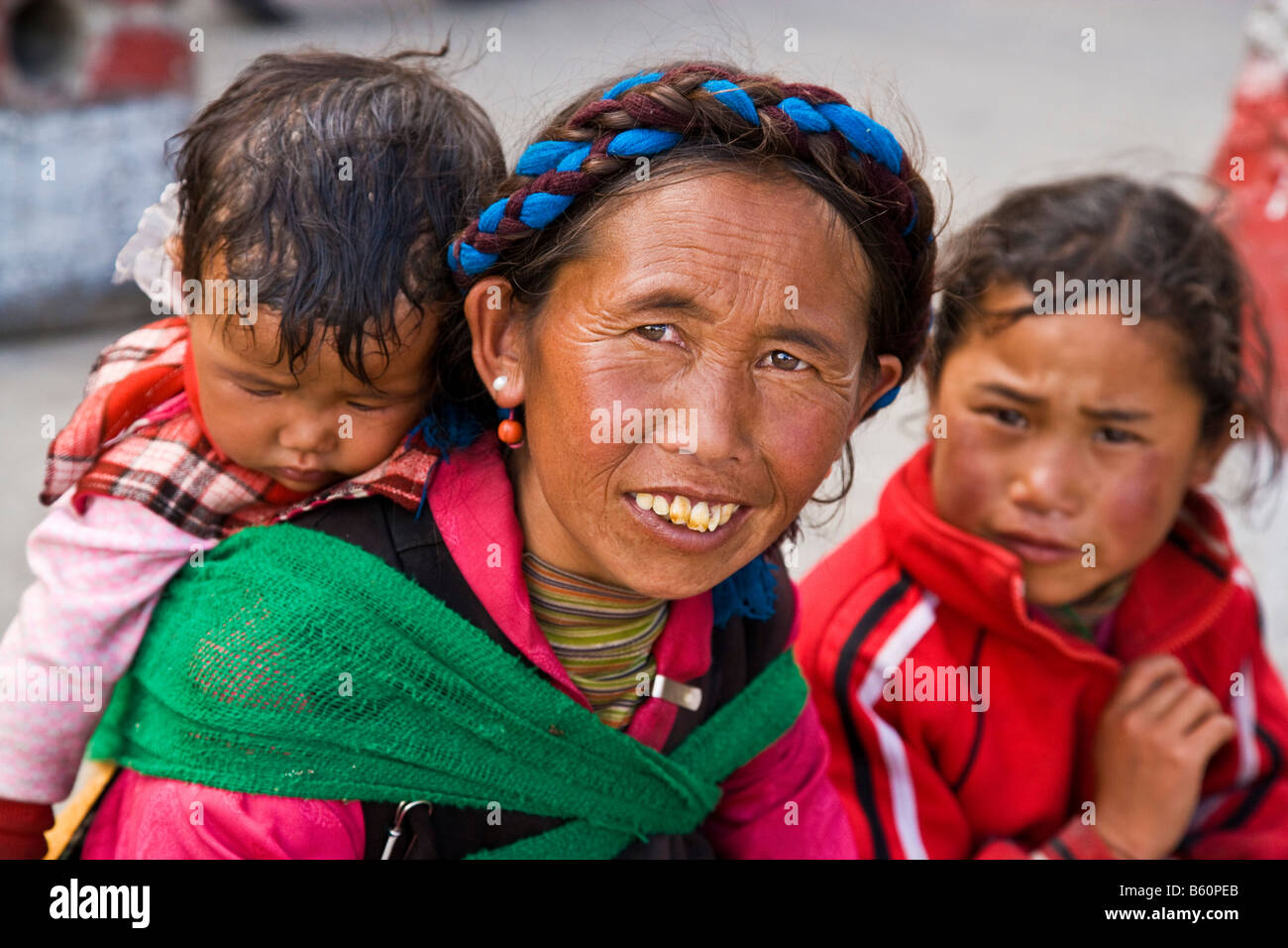 Tibetan woman with two children in the Barkhor Lhasa Tibet. JMH3690 ...