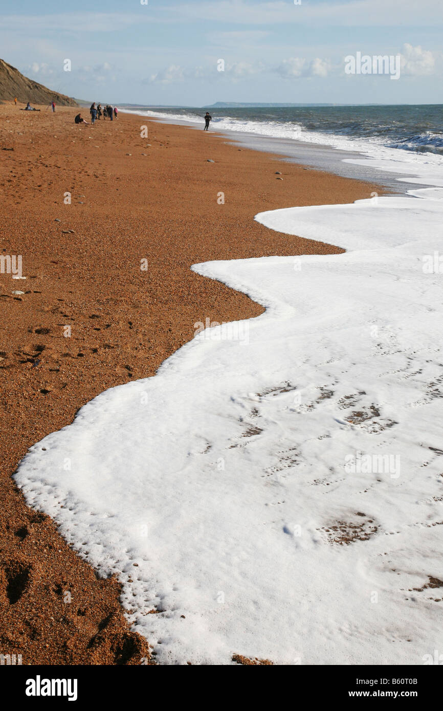Wash from waves rolling onto the shore of Chesil Beach at Burton ...