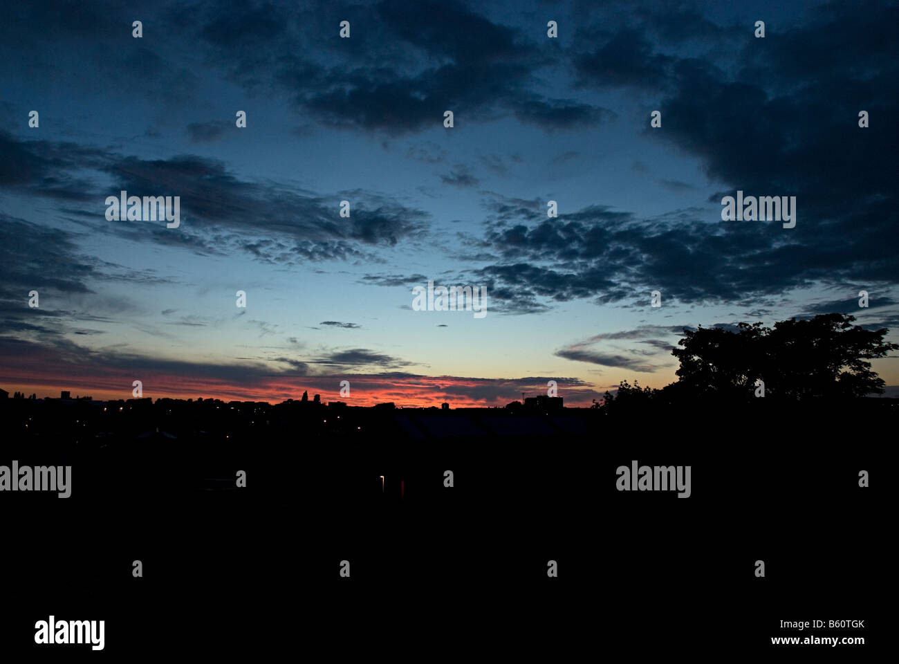 sunset sky over a large city Stock Photo - Alamy