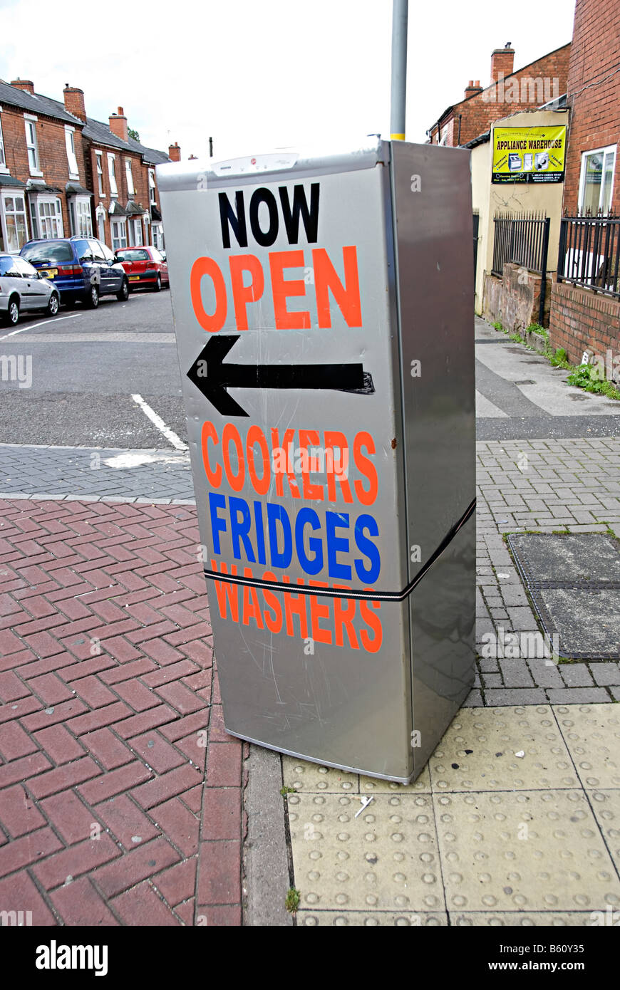 a for sale sign written on a fridge freezer in an urban street in ...