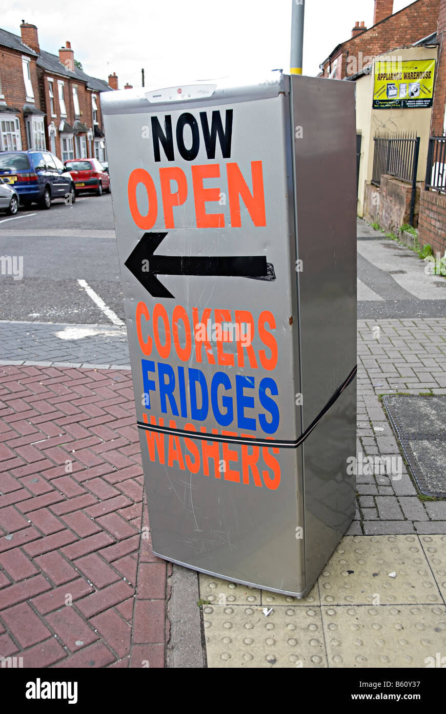 a for sale sign written on a fridge freezer in an urban street in ...