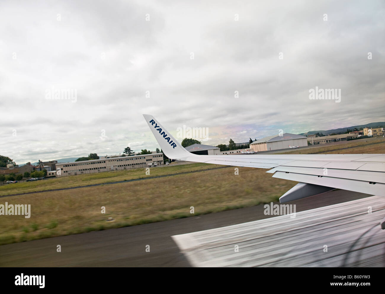 airplane wing in flight of a boeing 737 800 of a Ryanair plane on take ...