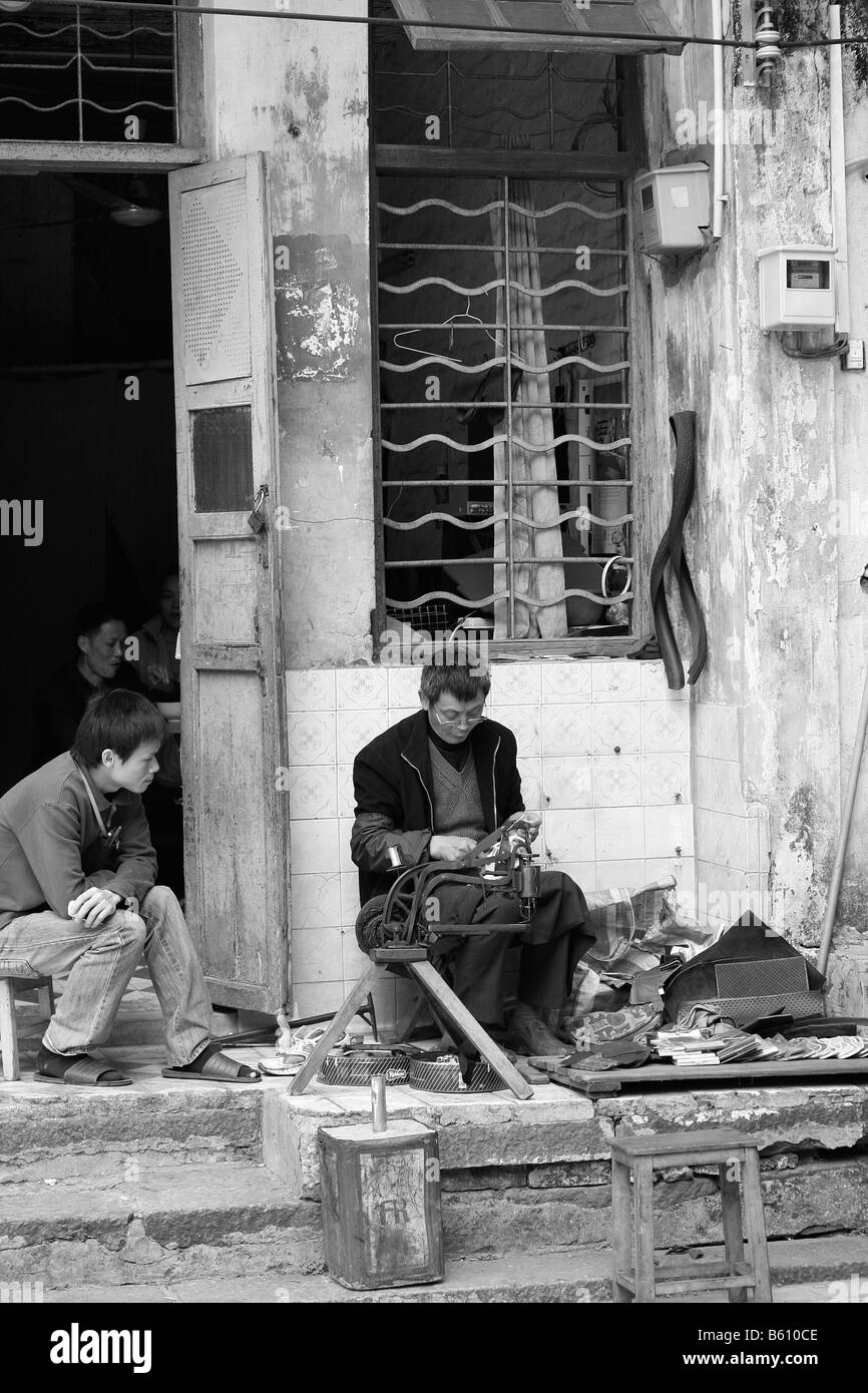 Local Chinese shoemakery handy man in Guangzhou China Black and white ...