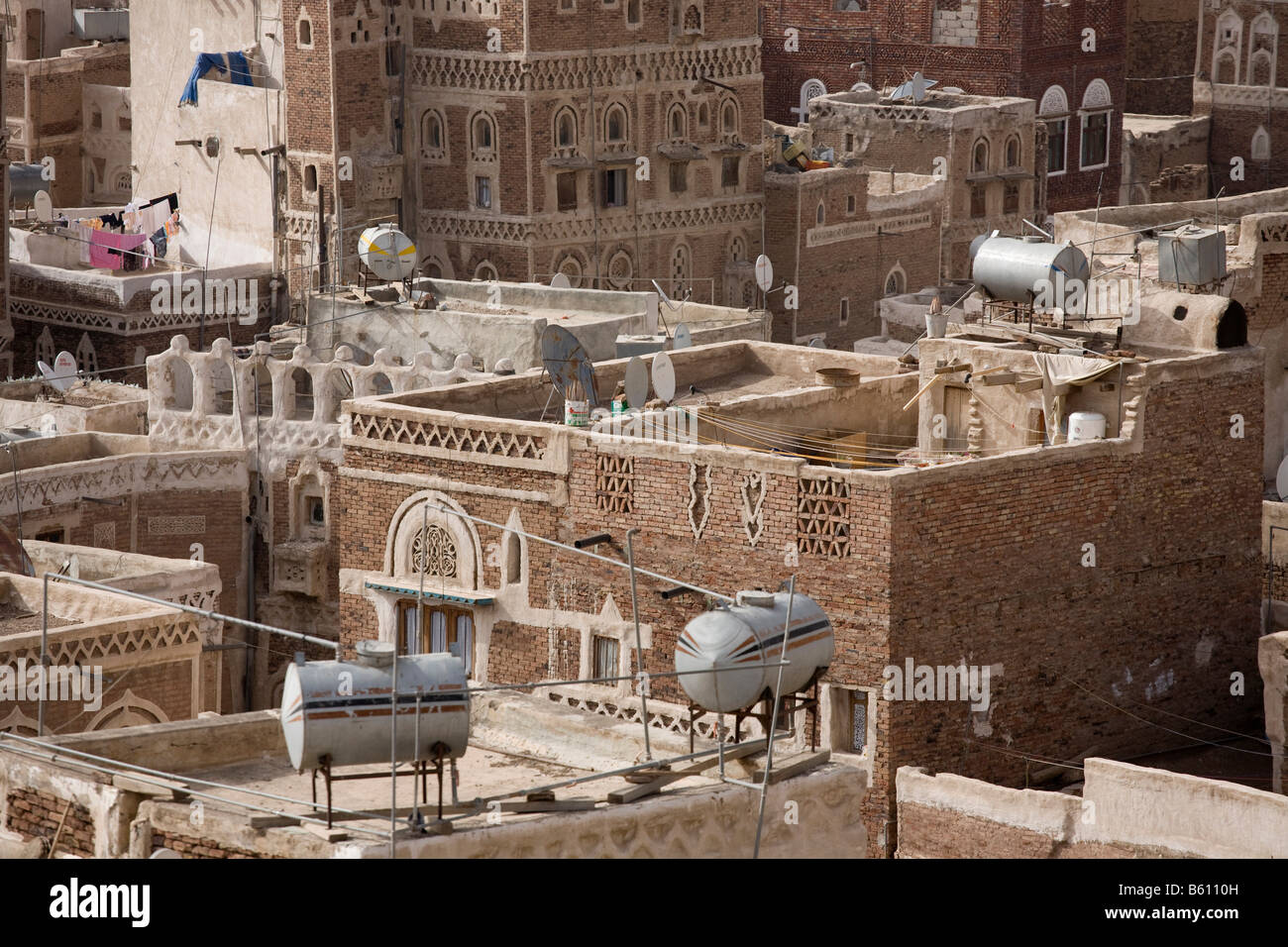 Satellite dishes, water tanks and washing on flat roofs, buildings made ...