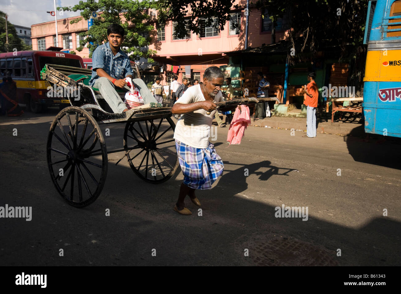 Indian man pulling rickshaw passenger hi-res stock photography and ...