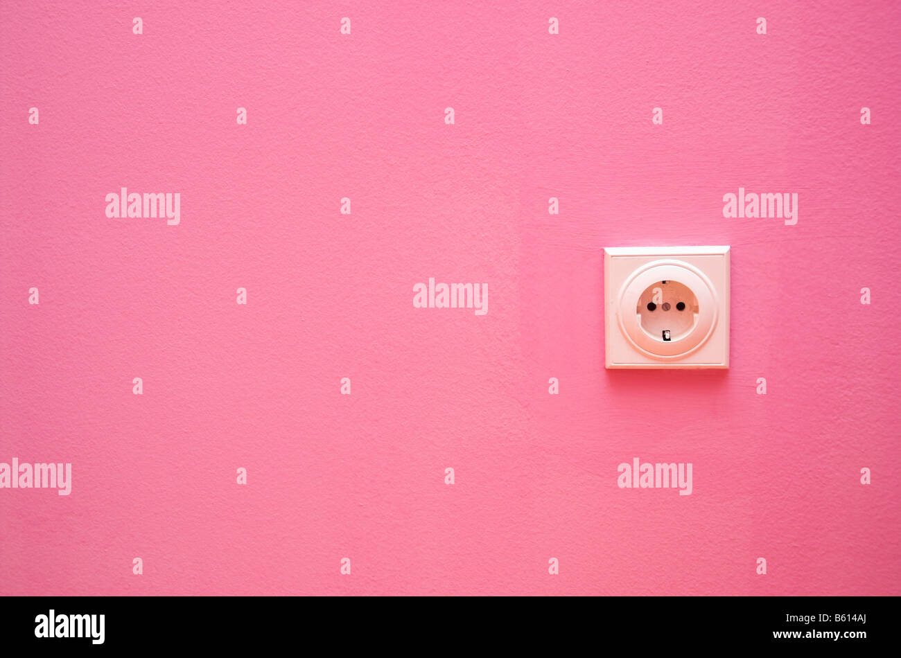 Electrical outlet on a pink wall Stock Photo - Alamy